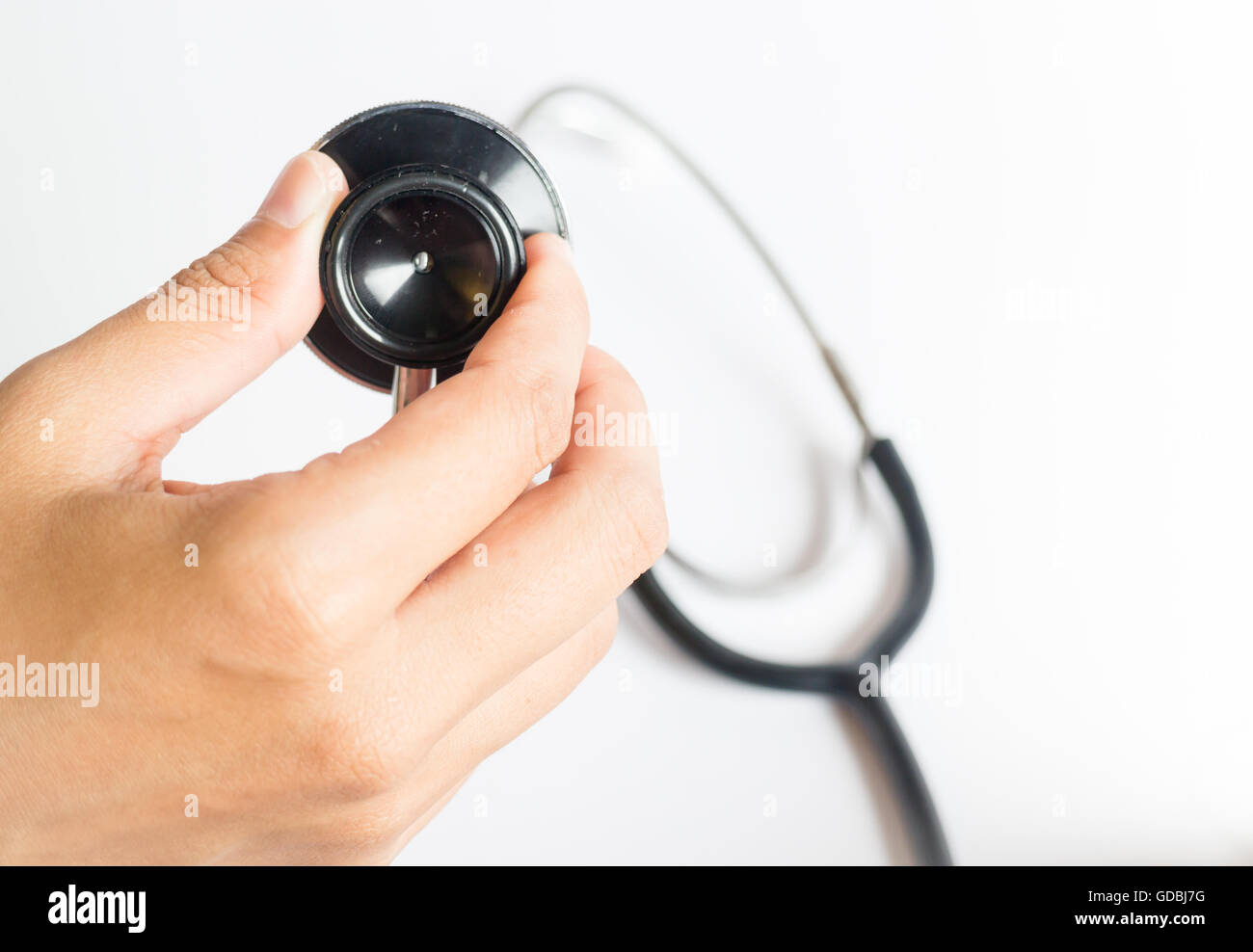 Hand on stethoscope on white background, stock photo Stock Photo - Alamy