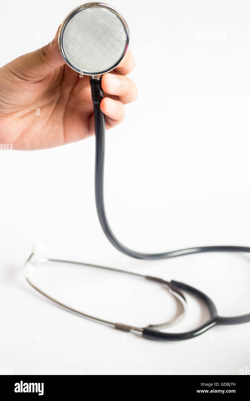 Hand on stethoscope on white background, stock photo Stock Photo - Alamy