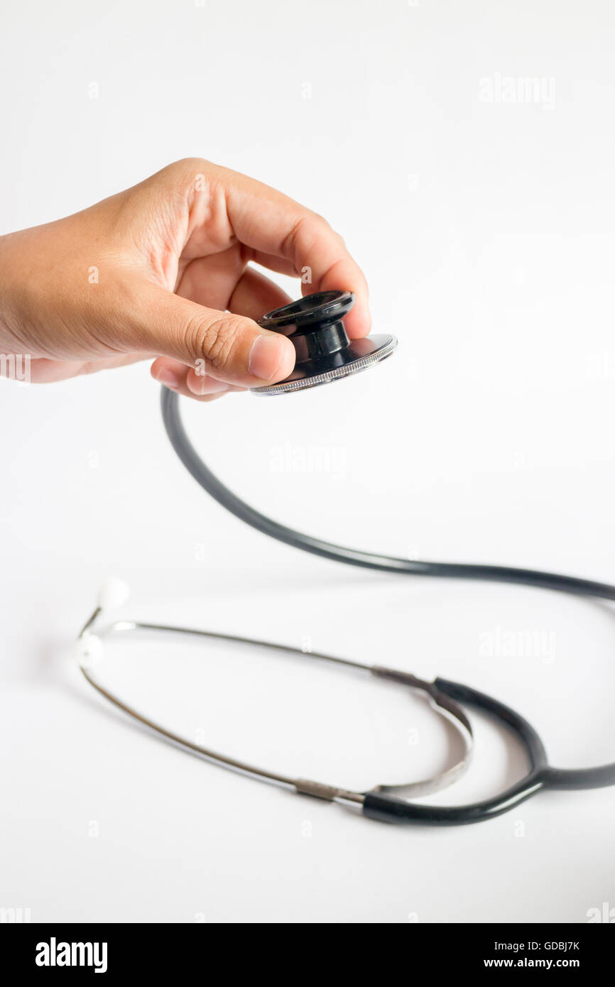 Hand on stethoscope on white background, stock photo Stock Photo - Alamy