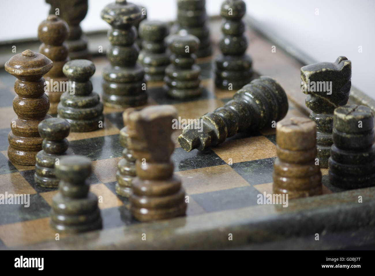 King Fallen Over on Stone Chess Board Stock Photo - Alamy