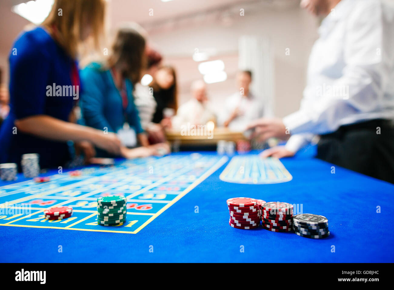 green roulette table with colored chips ready to play Stock Photo - Alamy