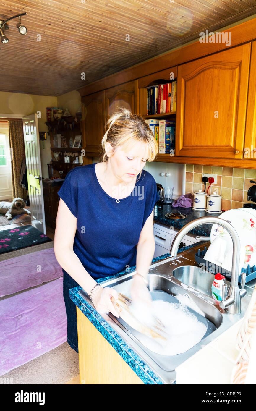 Woman washing up dishes pots cleaning at sink bowl clean cleaner washer ...