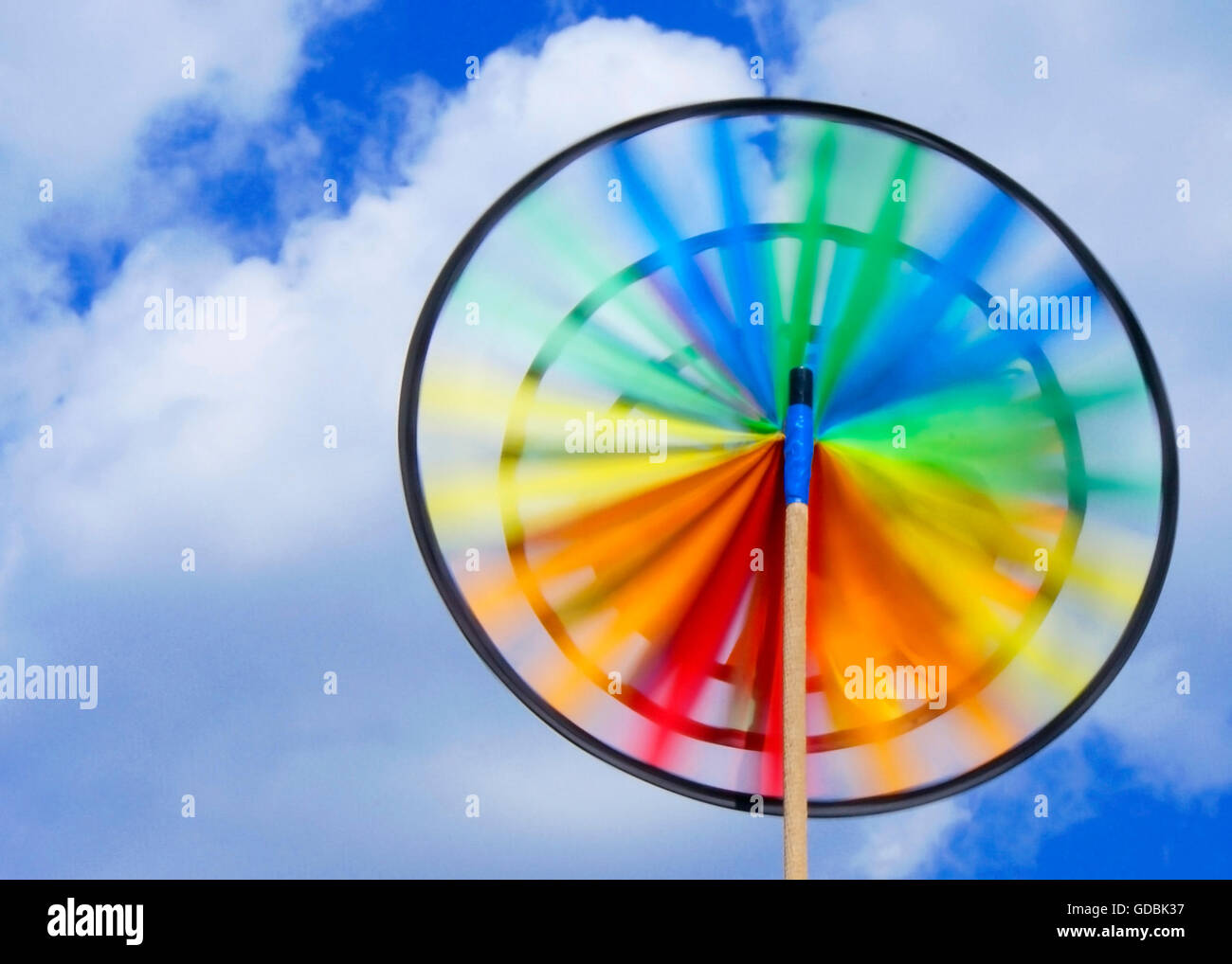 Rainbow colored pinwheel rotates in the summer sky Stock Photo - Alamy