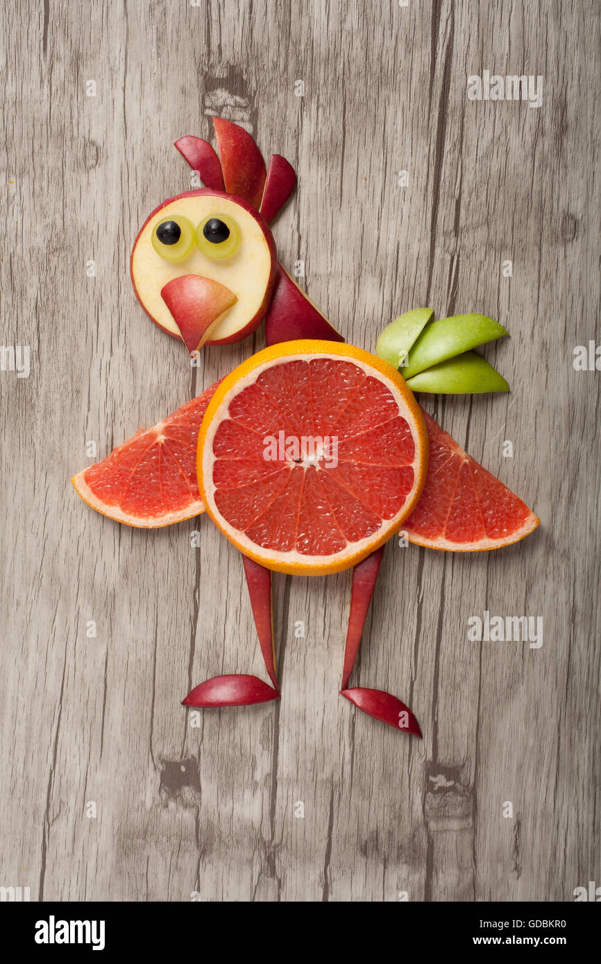 Funny chicken made of fruits on wooden background Stock Photo - Alamy