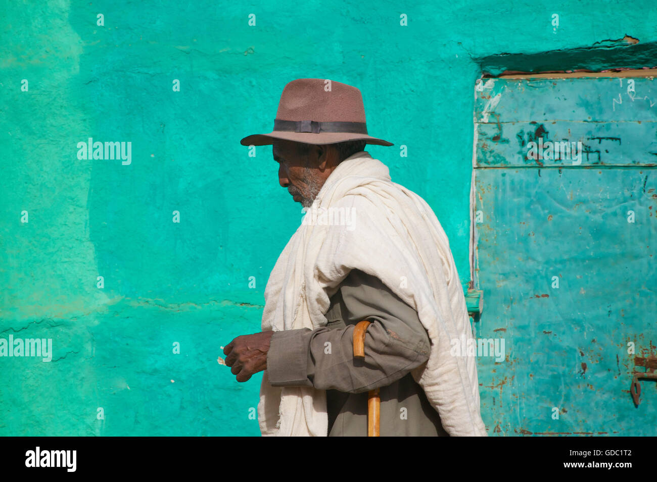 Ethiopian man walking in a suit with traditional cloak around his ...