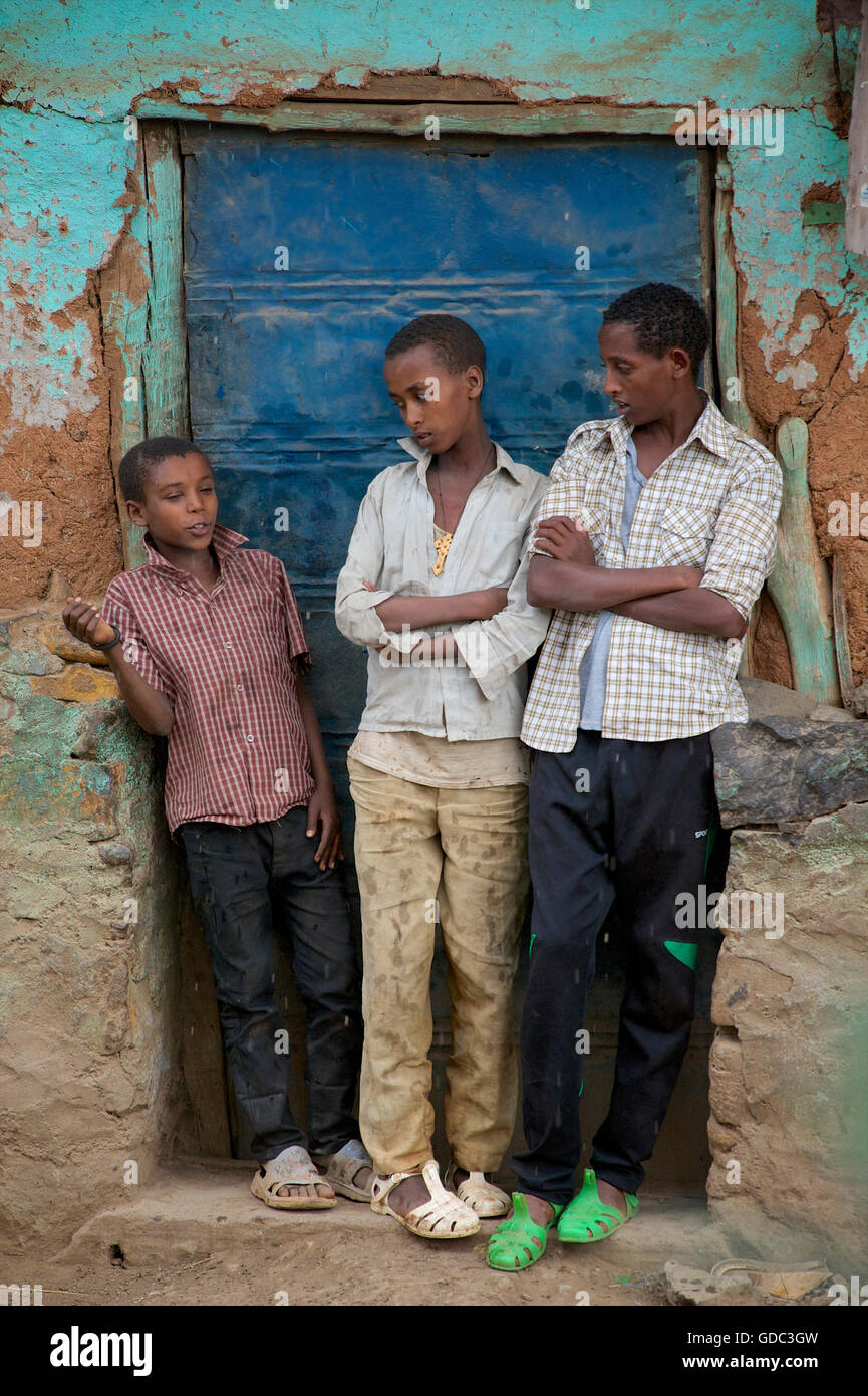 Ethiopian boys sheltering from the rain outside a shop. Addi Arkay ...