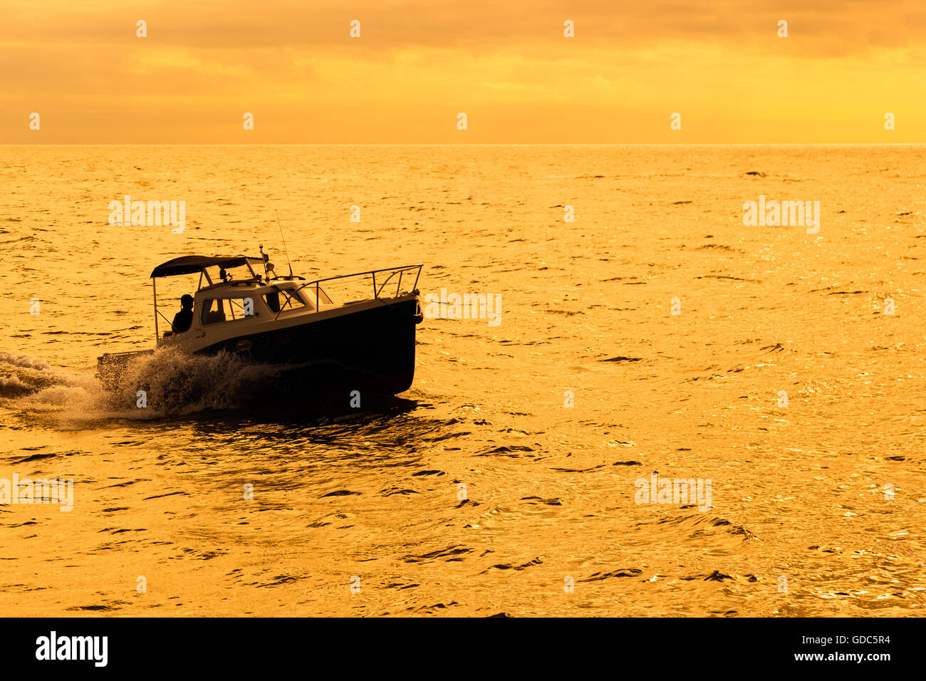 Fishing boat coming sunset hi-res stock photography and images - Alamy