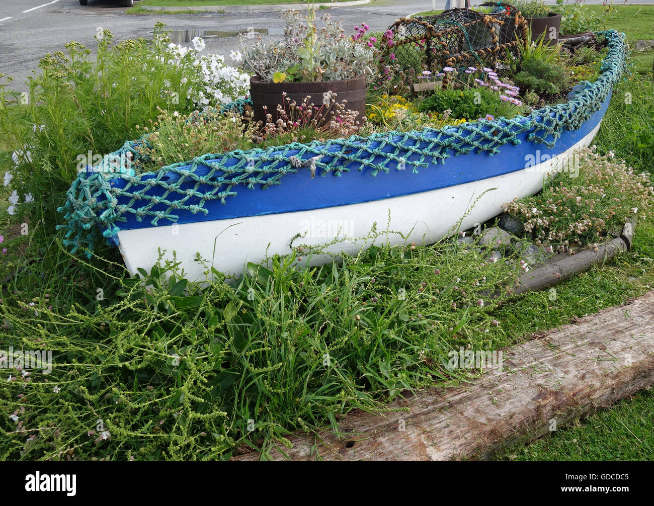 Decorated boat turned into a planter Stock Photo - Alamy
