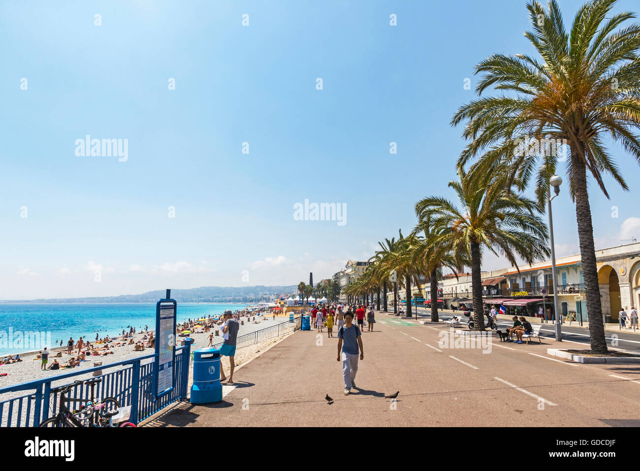 People walk on Promenade des Anglais in City of Nice, Cote D'azur ...