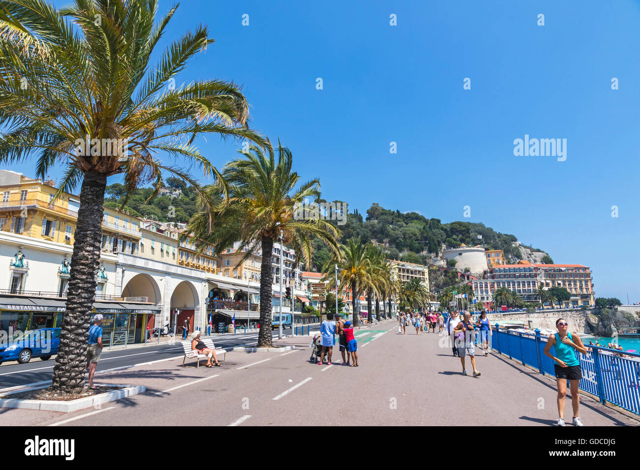 People walk on Promenade des Anglais in City of Nice, Cote D'azur ...