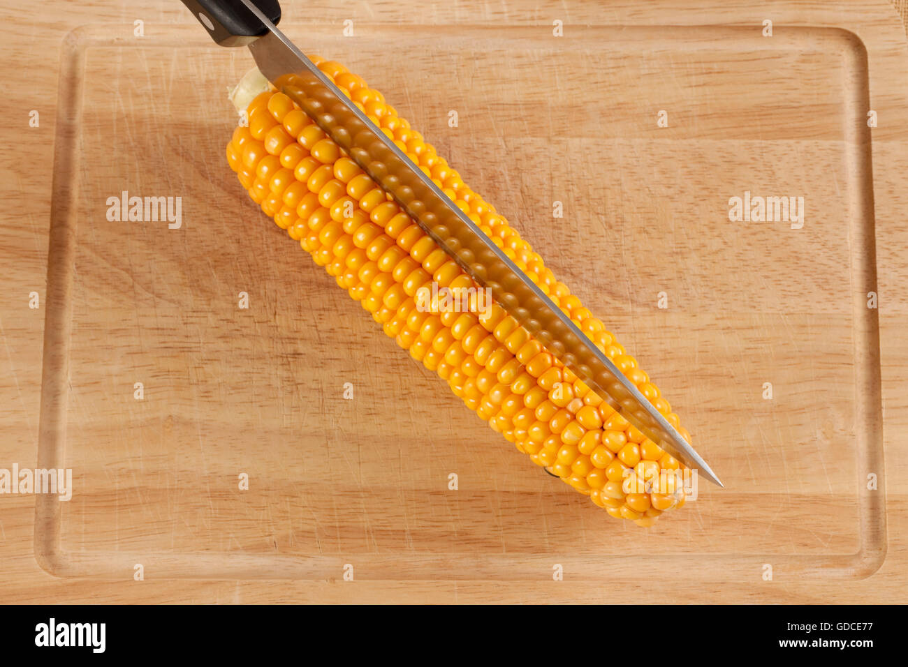 Corn or maize cob with kitchen knife Stock Photo - Alamy