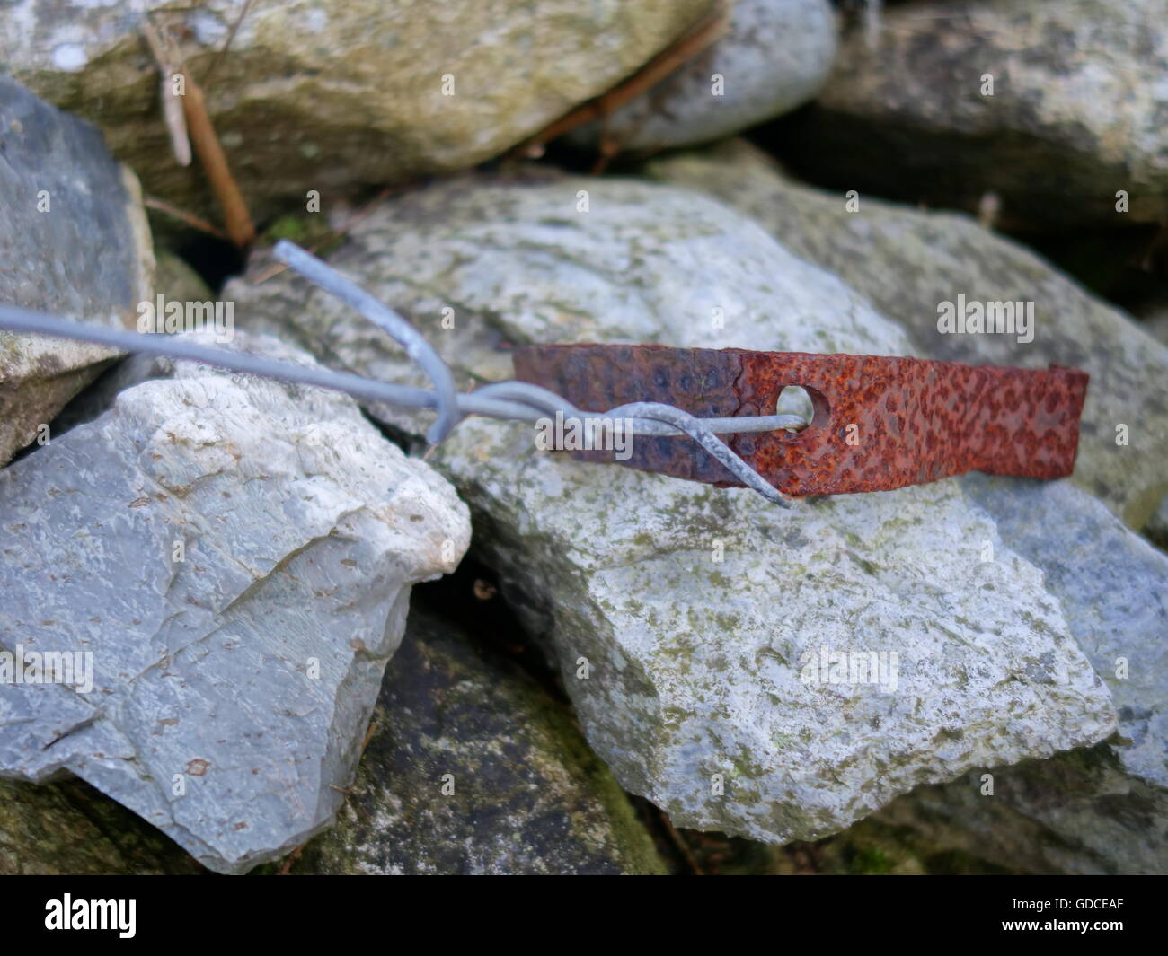Rusty tie on a rock Stock Photo - Alamy