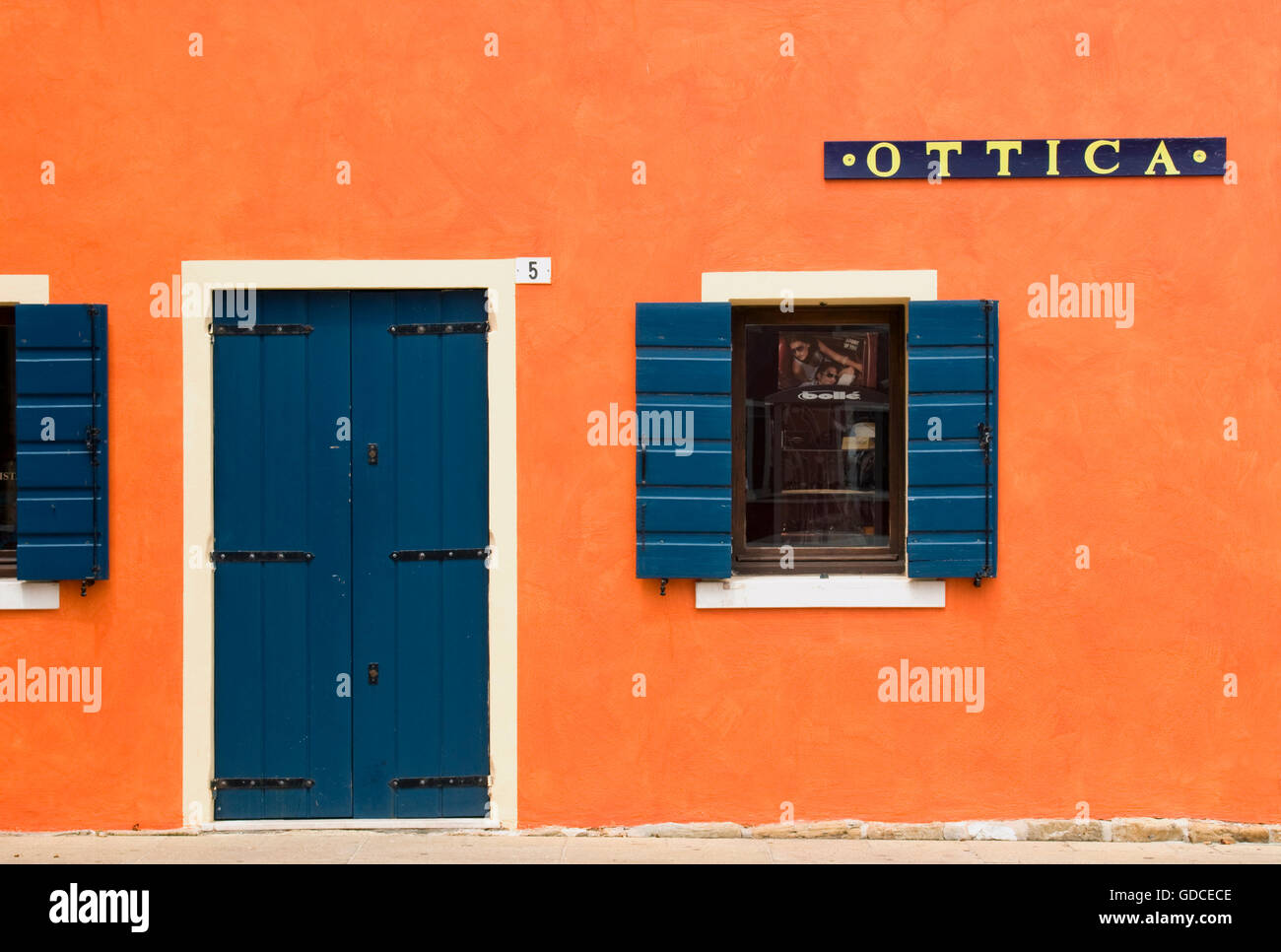 Brightly painted facade of house, historic town centre of Caorle ...