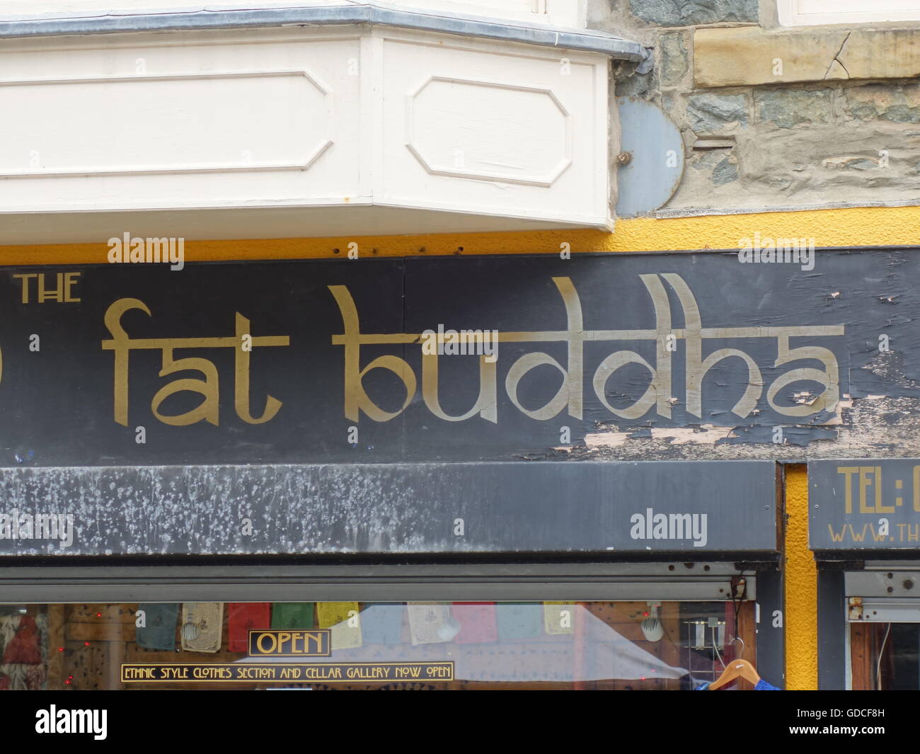 The Fat Buddha rustic sign on the front of a shop Stock Photo - Alamy
