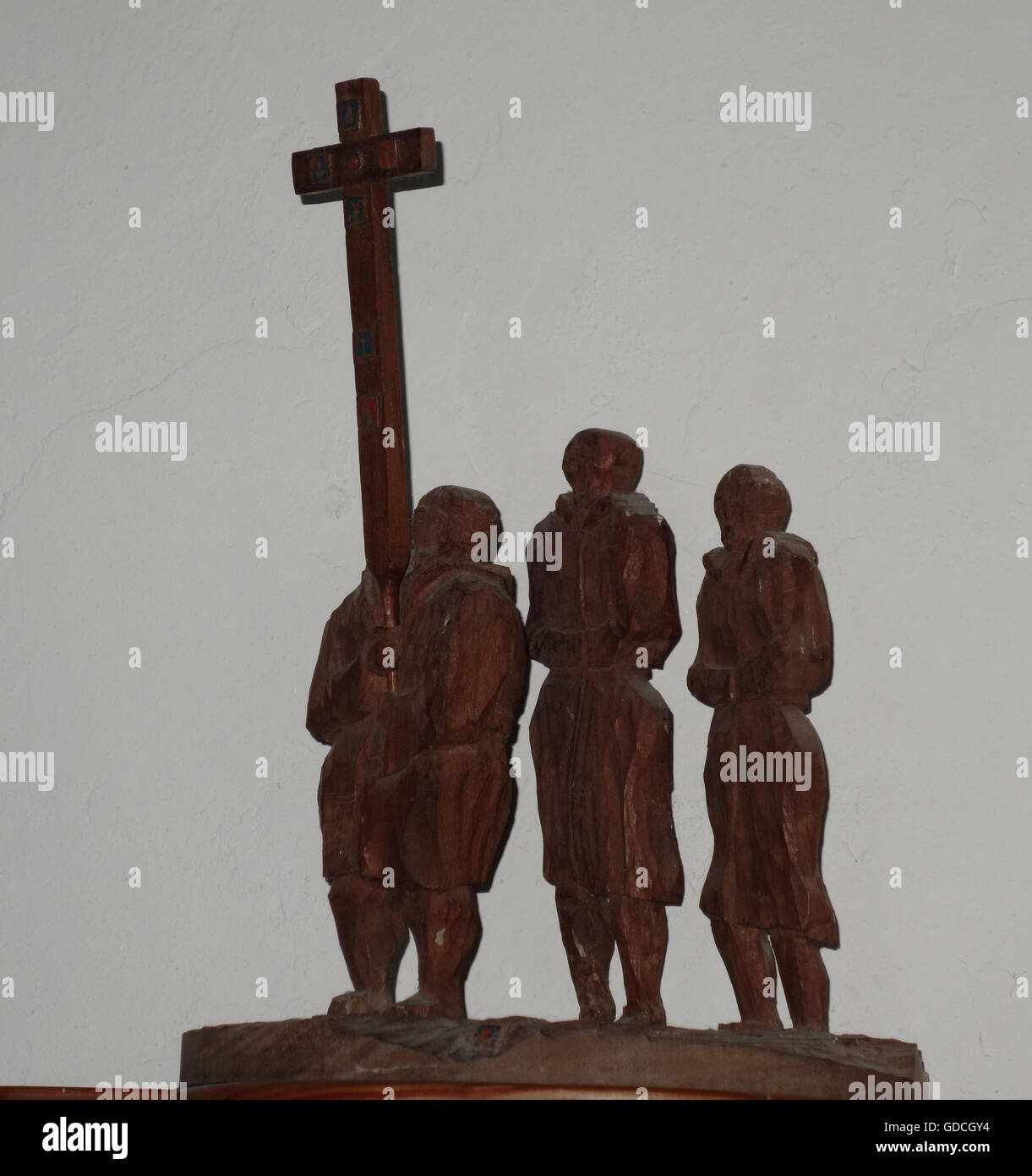 An ancient wooden carving of characters carrying a cross Stock Photo ...
