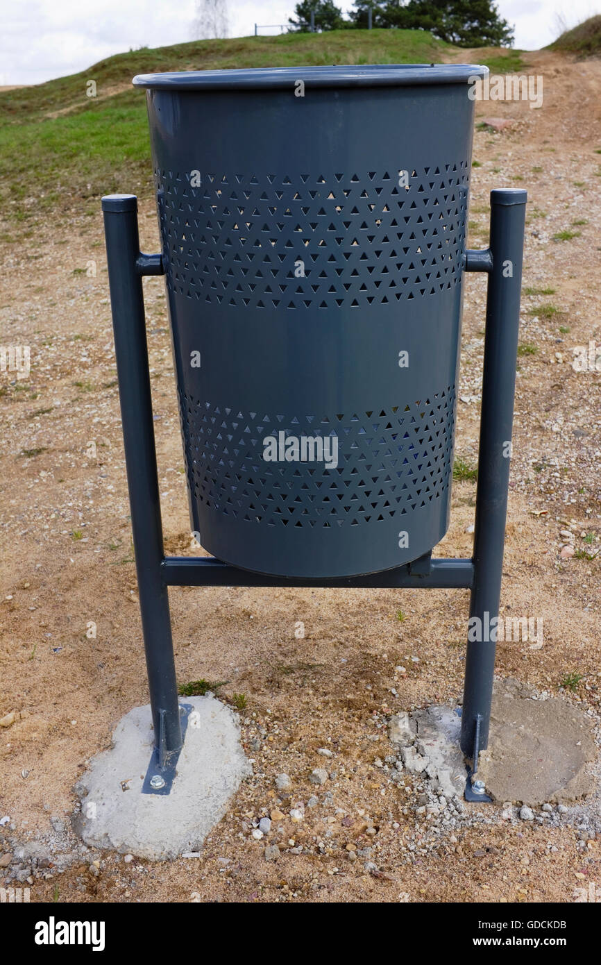New empty tin basket for garbage (recycle bin) concept on the sandy ...