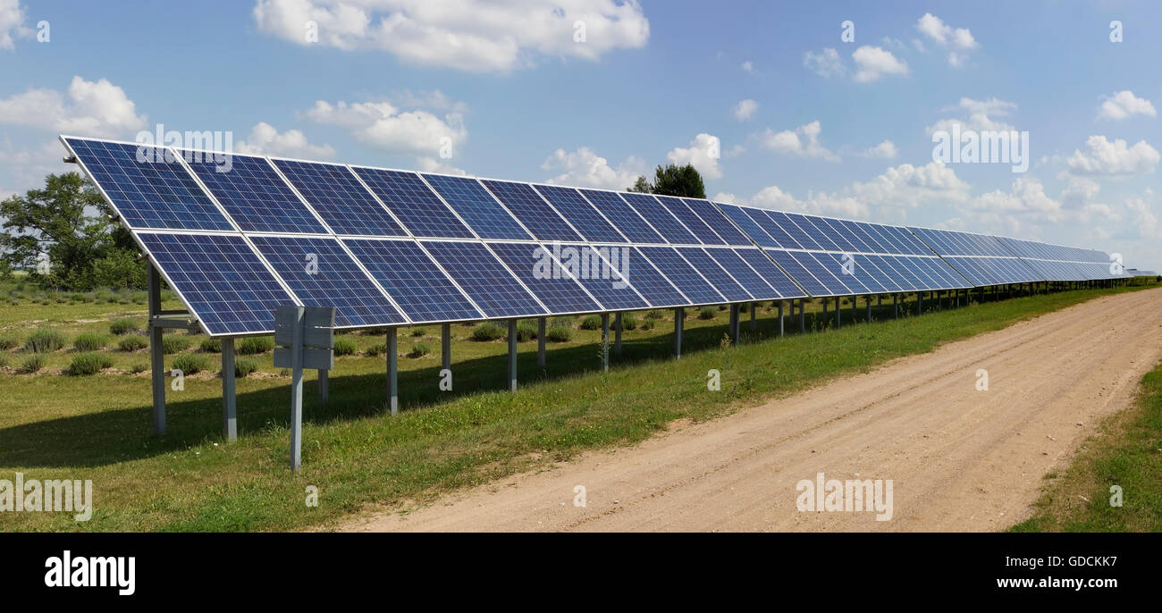 Long line of no name solar electric generation panels is near the rural ...