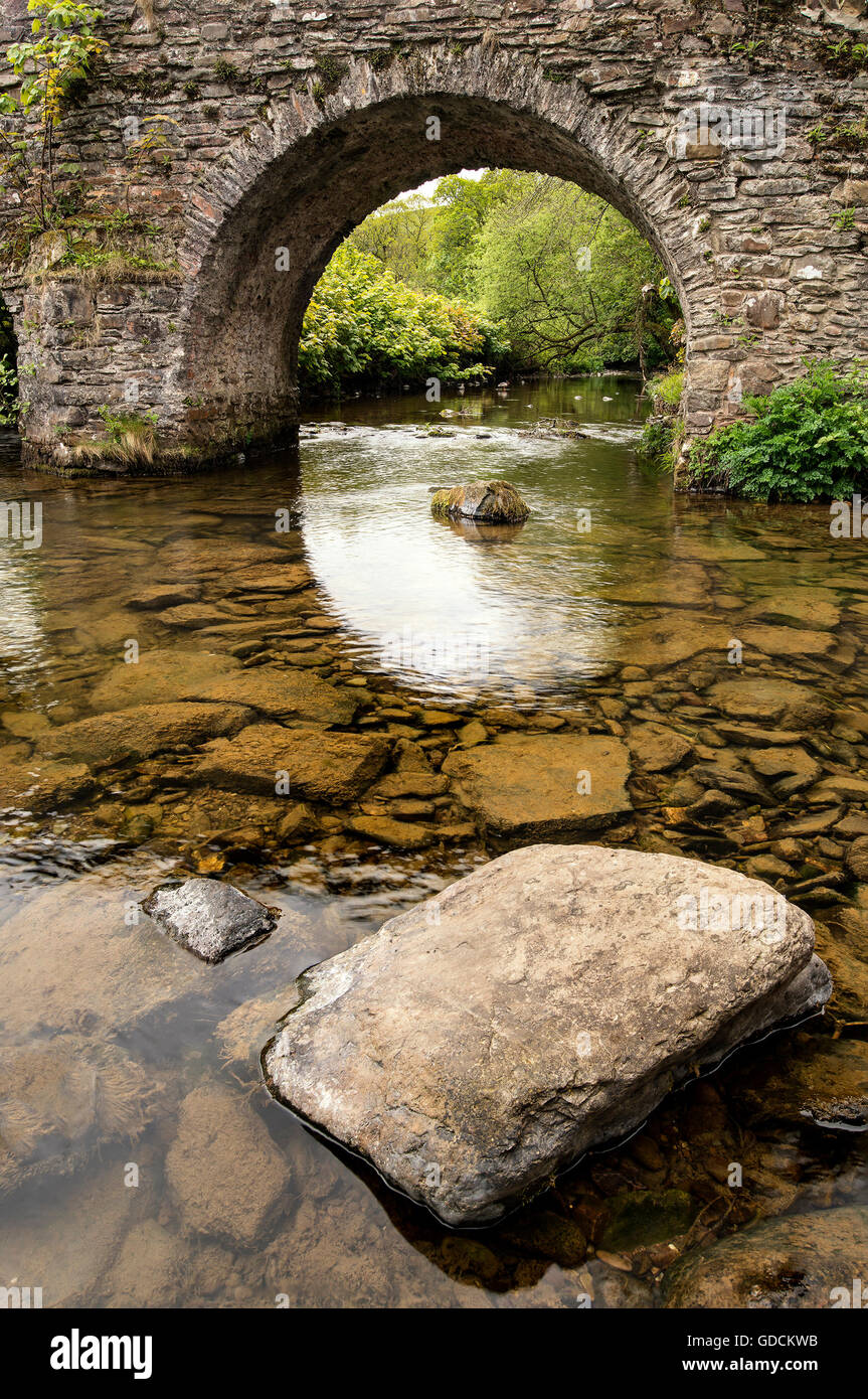Landscape image of old medieval bridge in river setting in English ...