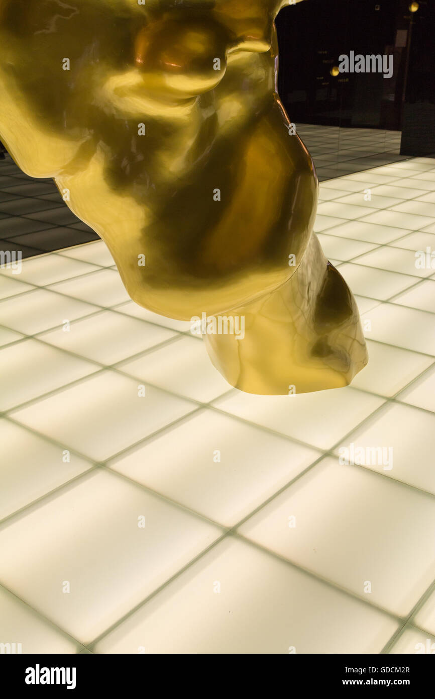 White Floor with Backlight Tile and Golden Sculpture Stock Photo - Alamy