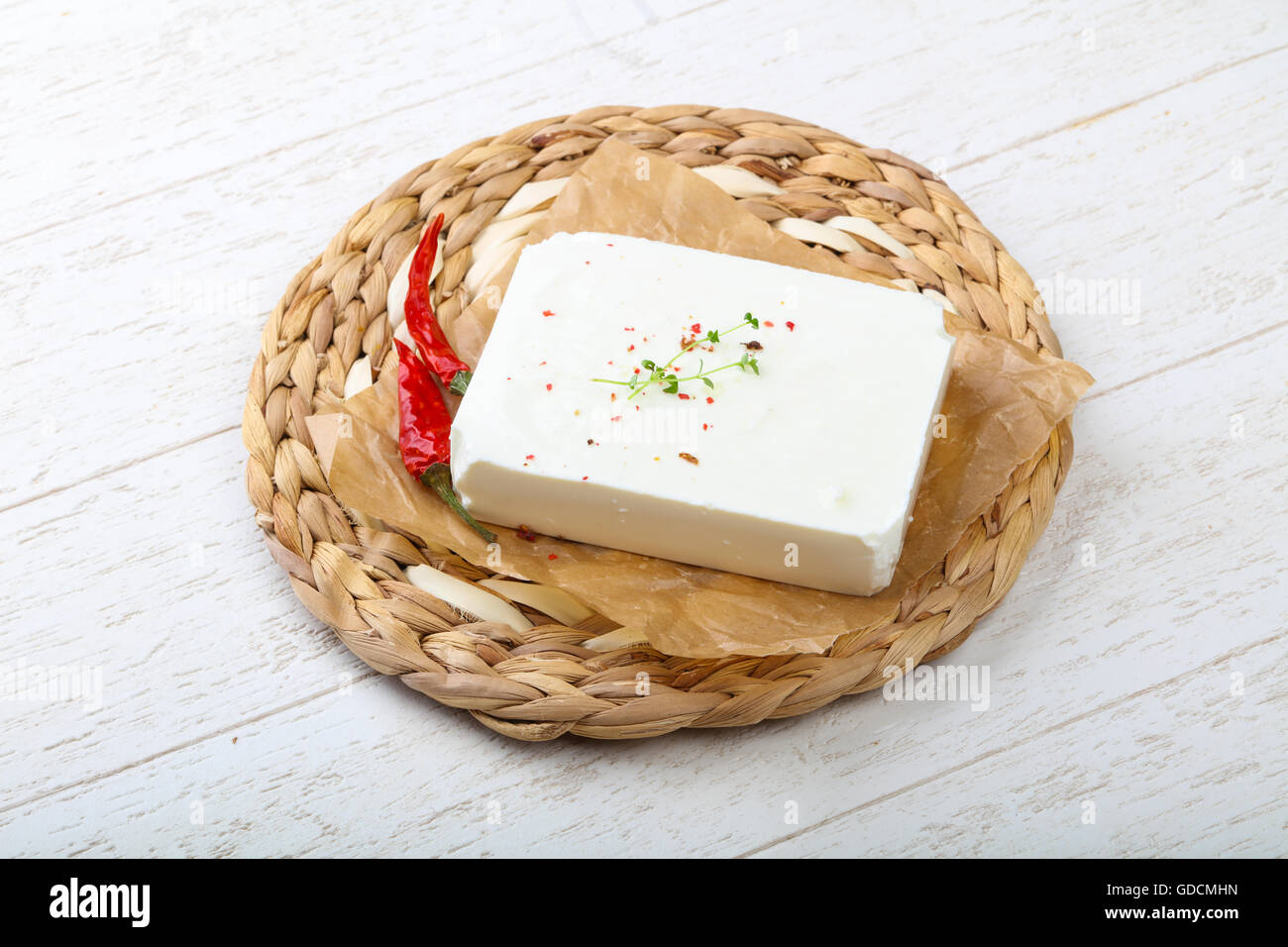 Feta brick cheese on the board wth thyme and pepper Stock Photo - Alamy