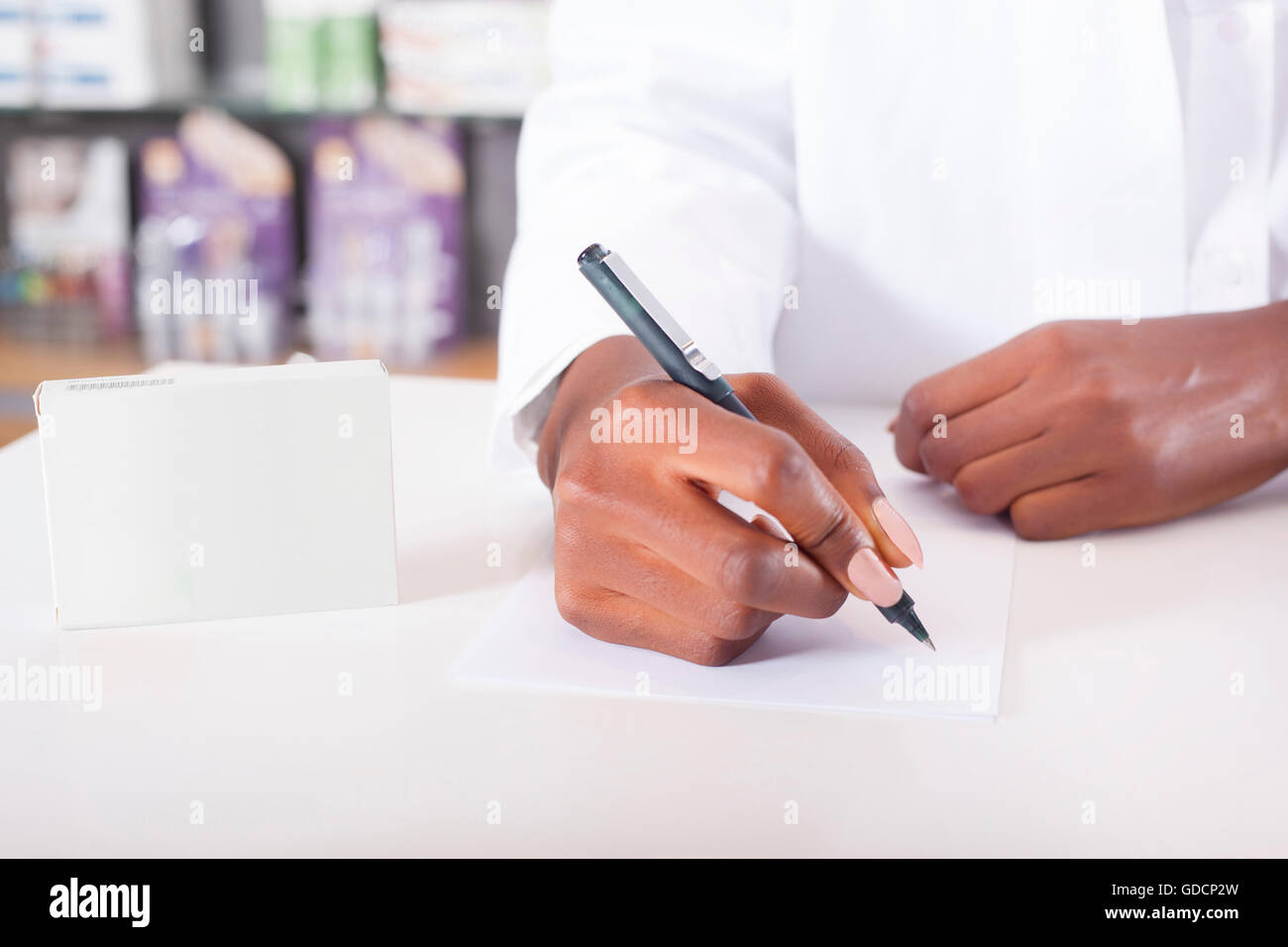 Pharmacist or doctor writing with tablet package with copy space Stock ...