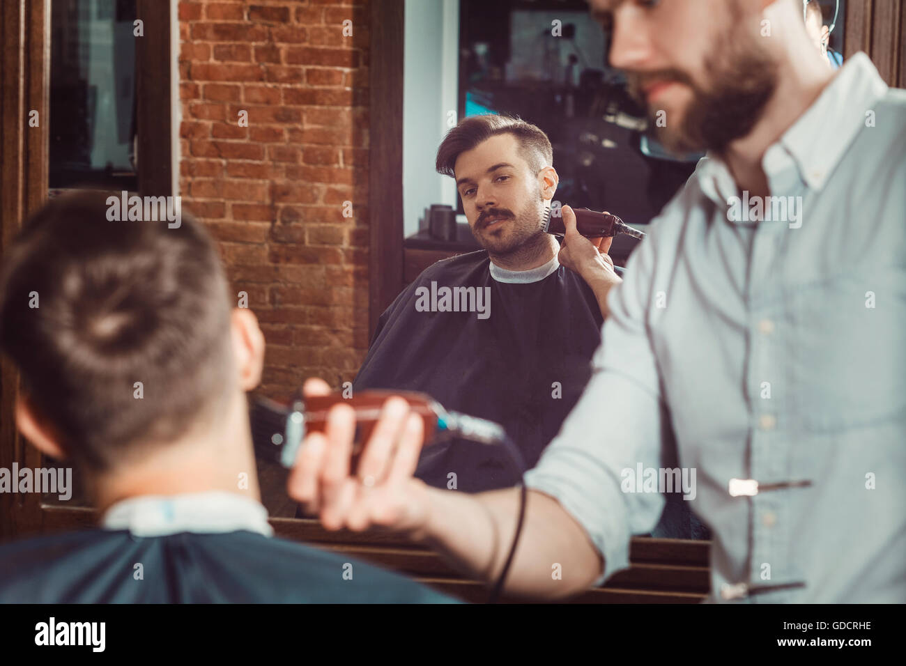 Hipster client visiting barber shop Stock Photo - Alamy