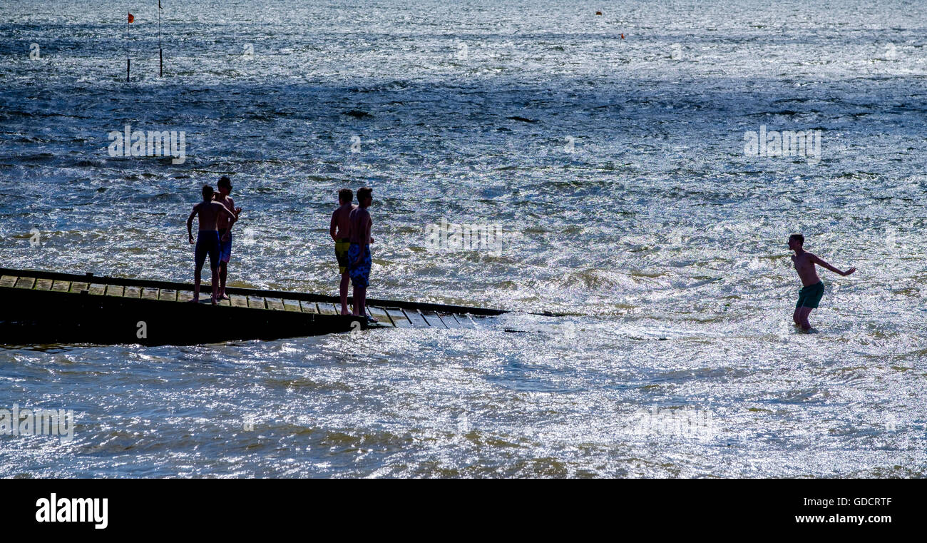 Children playing in the sea off Whitstable, Kent England Stock Photo ...