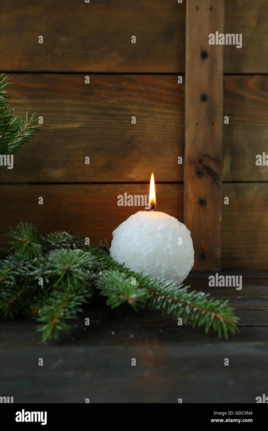 one white christmas candles and spruce Stock Photo - Alamy