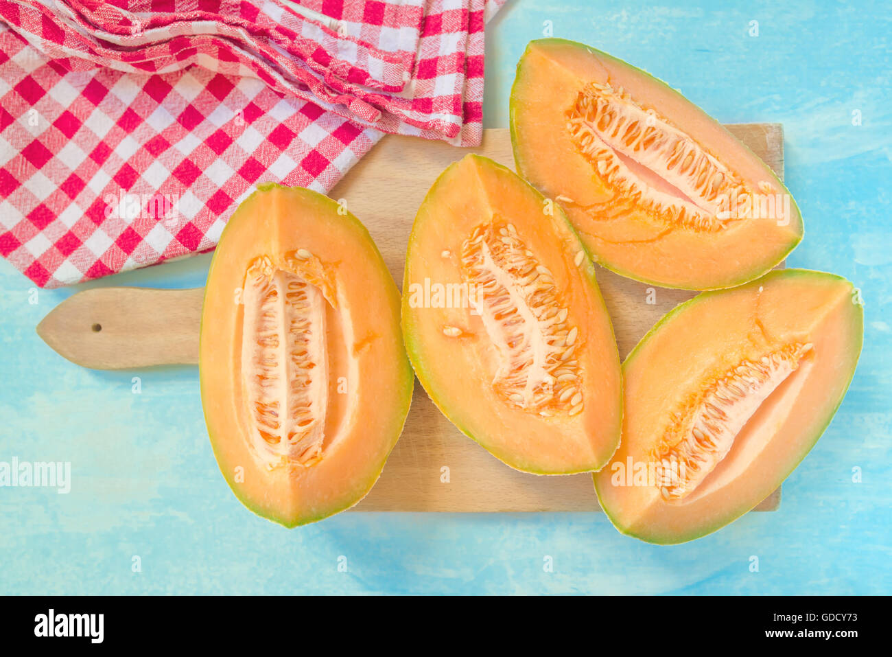Melon on rustic wooden table, selective focus Stock Photo - Alamy