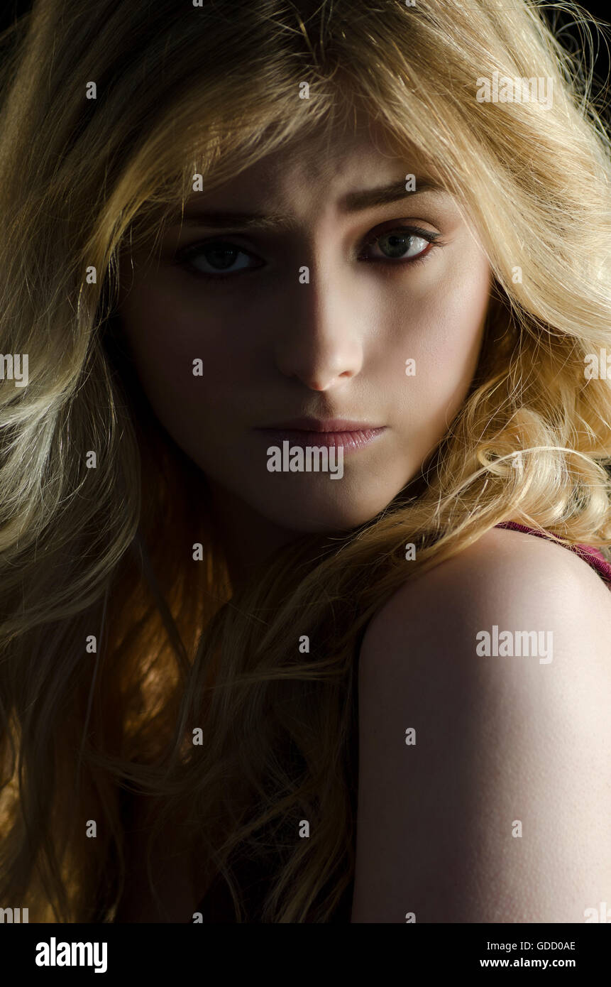 Shadowy portrait of a scared woman Stock Photo - Alamy