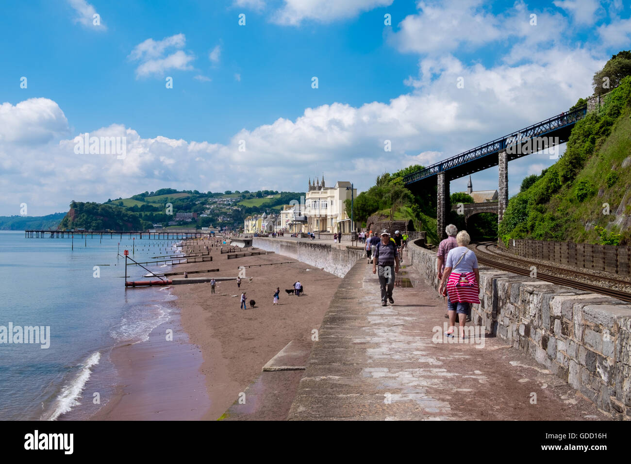 People walking along the sea wall at Teignmouth near Dawlish, Devon ...