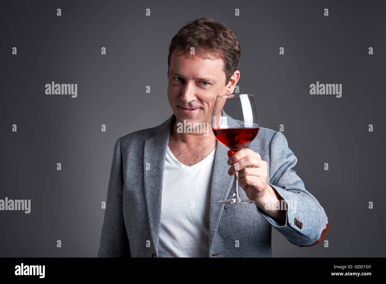 A middle age man toasting with a glass of wine Stock Photo - Alamy