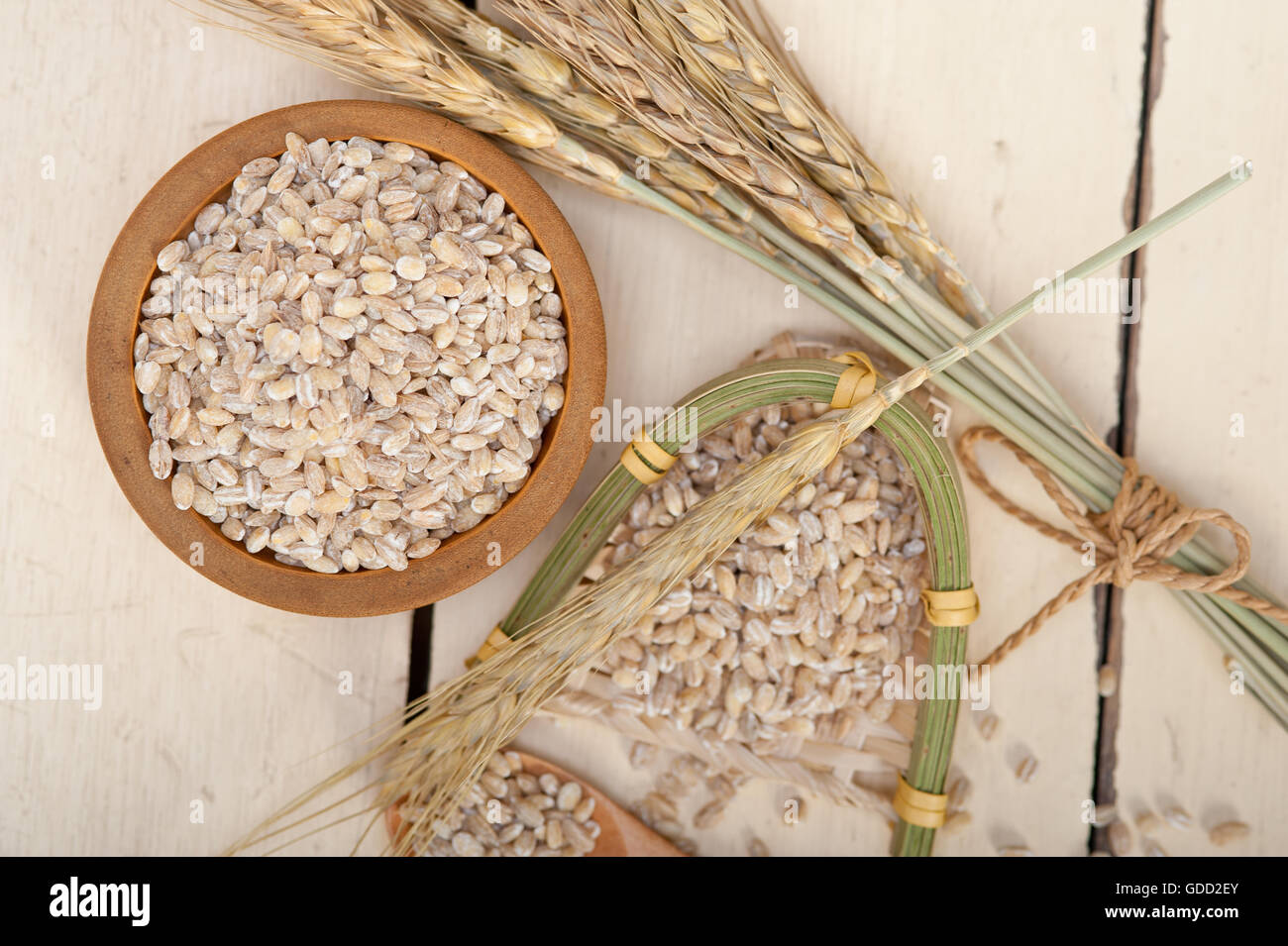 organic wheat grains over rustic wood table macro closeup Stock Photo ...