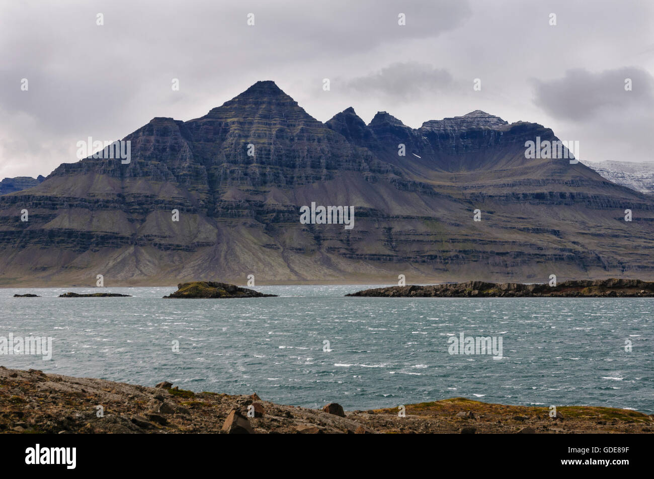 The pyramid-shaped mountain Bulandstindur in the fjord Berufjördur in ...