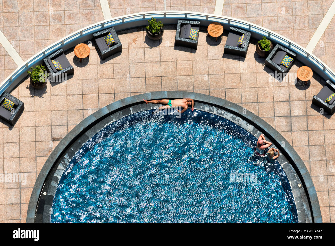 Guests sunbathing at a hotel swimming pool, Bangkok,Thailand Stock ...