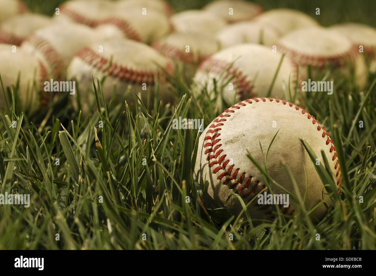 Nostalgic baseballs in the grass on a baseball field Stock Photo - Alamy