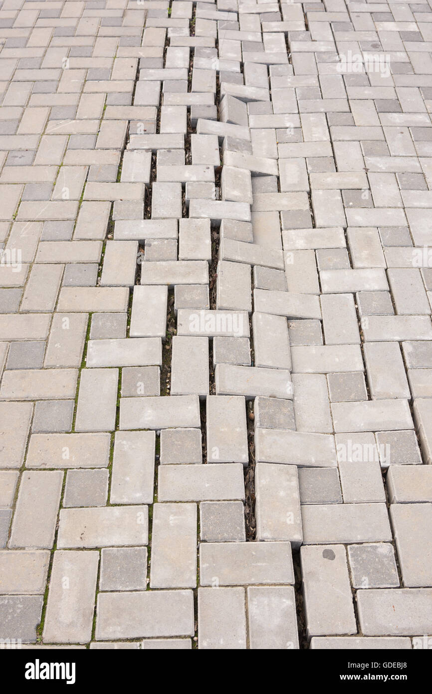 A large crack in the paving tiles Stock Photo - Alamy