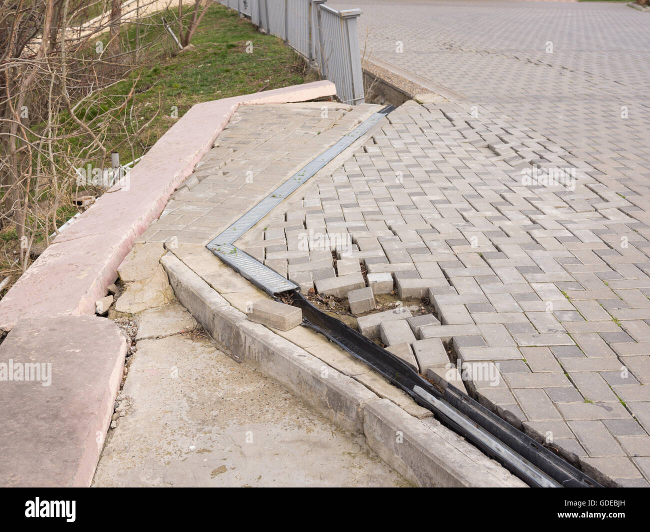 The destruction of the pedestrian walkway of pavers fixed concrete ...