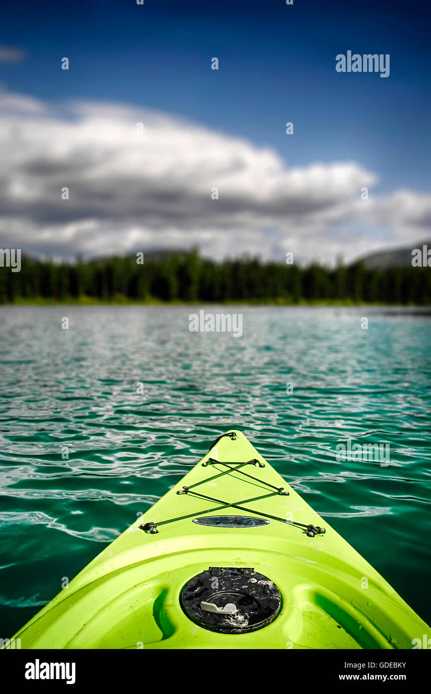 Neon green kayak on the water at Horseshoe Lake, Montana Stock Photo ...