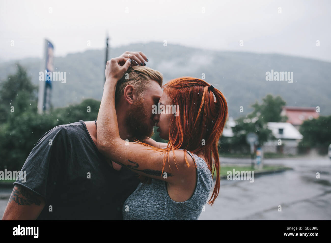 beautiful couple hugging in the rain Stock Photo - Alamy