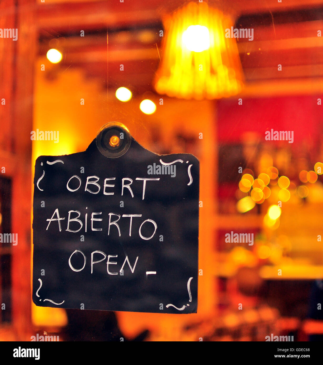Open sign on english, catalan and spanish Stock Photo - Alamy