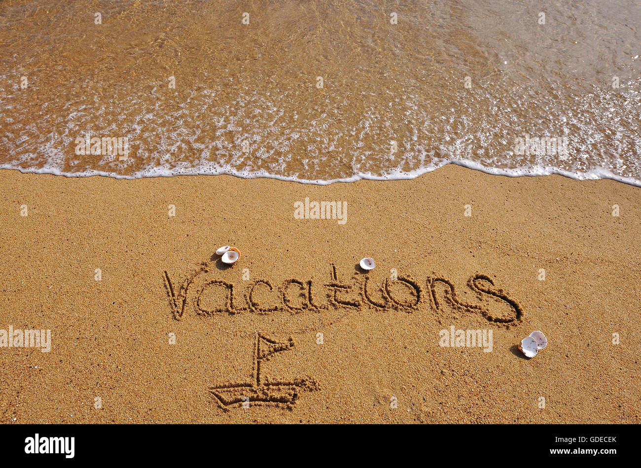 Vacations sign on the beach Stock Photo - Alamy