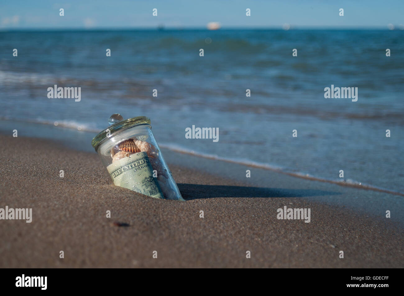 Dollar in sand hi-res stock photography and images - Alamy