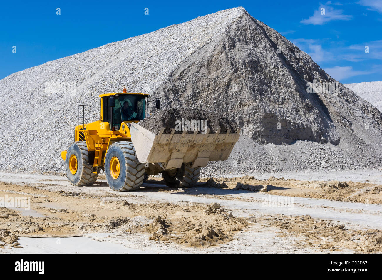 forklift - warehouse production in quarry blue clay on sky background ...