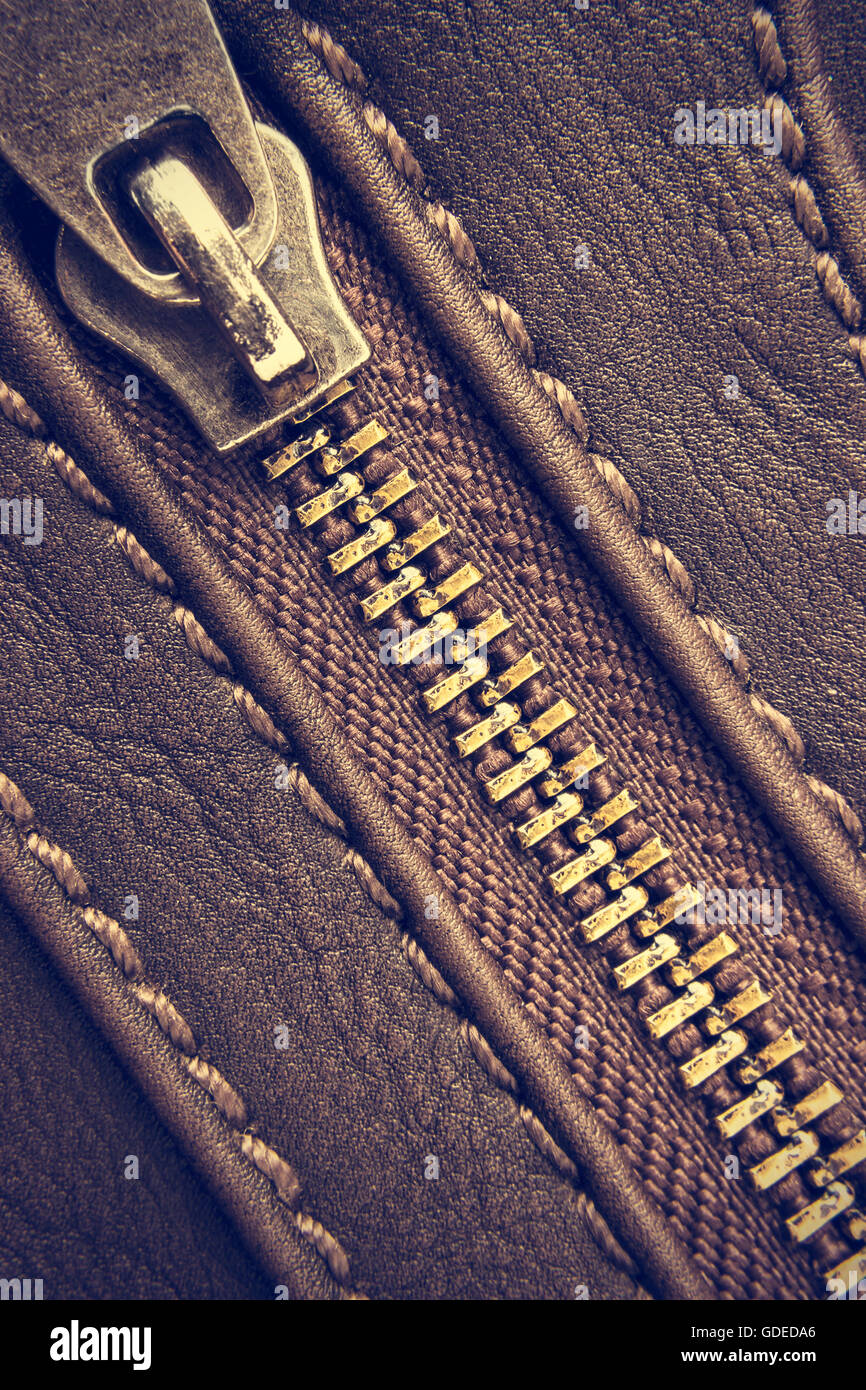 Macro of a closed zipper of leather bag. Vintage style. Vertical image ...