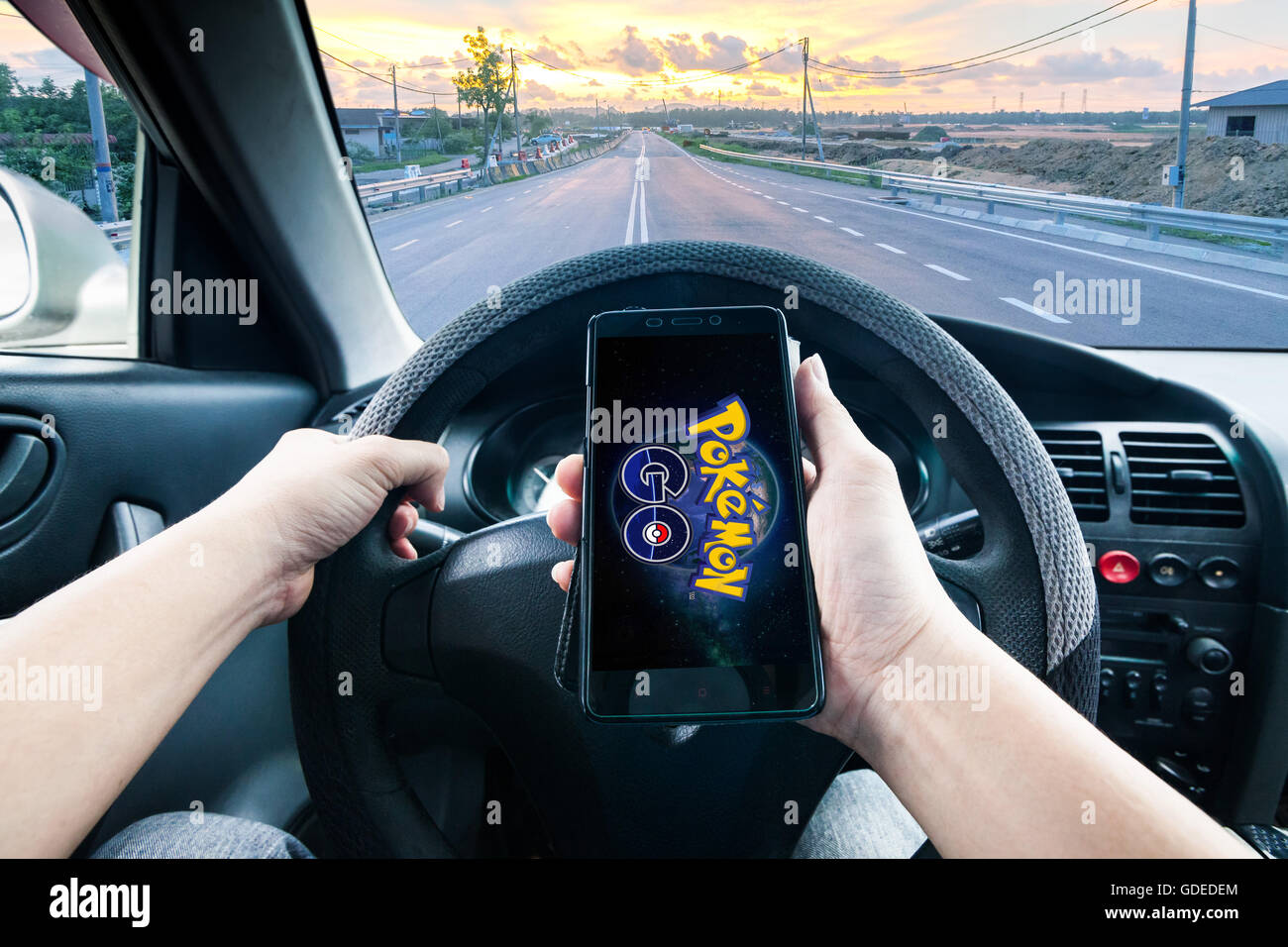 Pokemon Go game while dangerous driving Stock Photo - Alamy