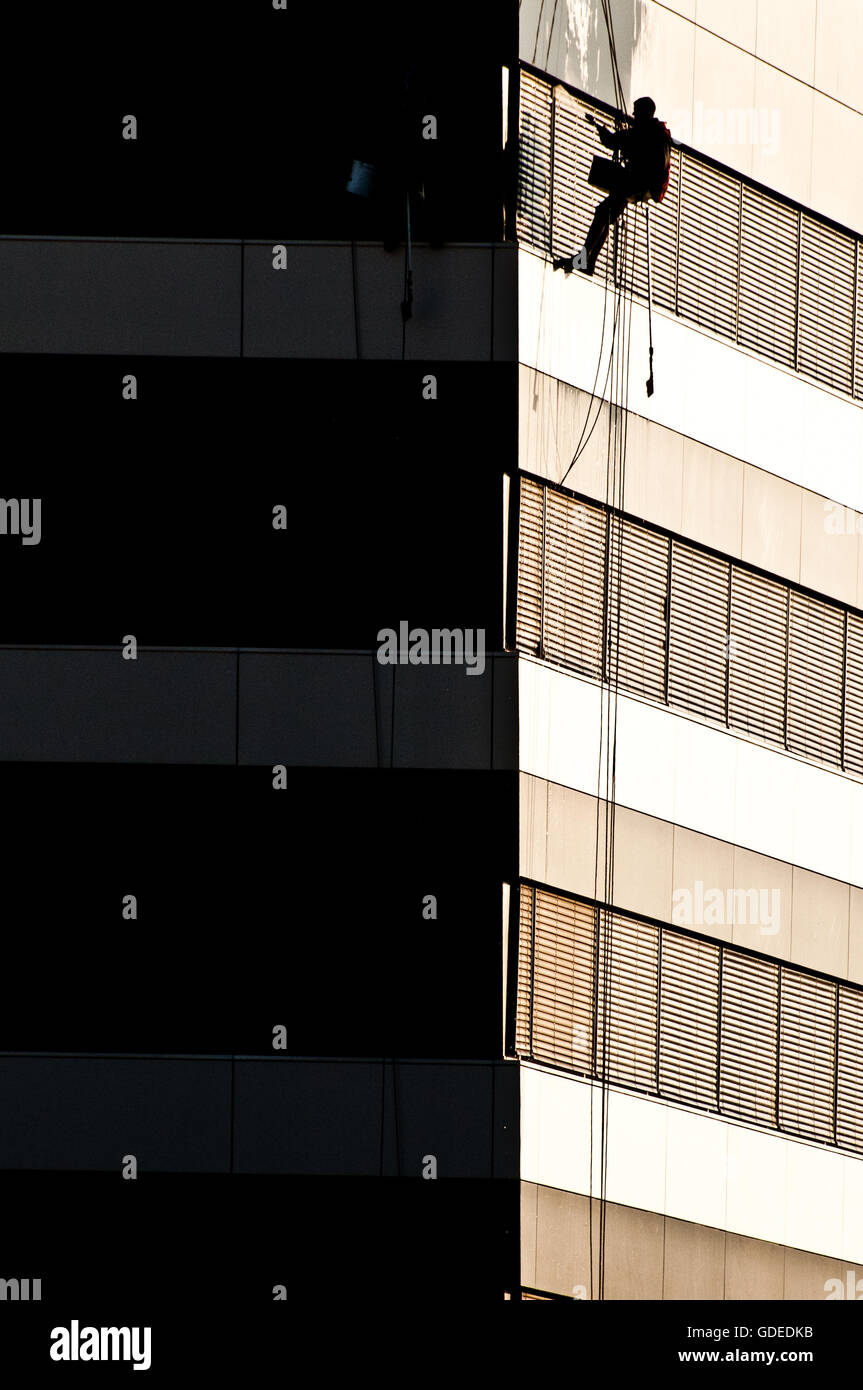 windows cleaner of modern building on rope Stock Photo - Alamy
