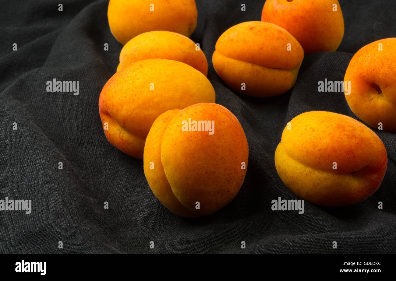 fresh ripe apricots in red plate on black background, closeup Stock ...