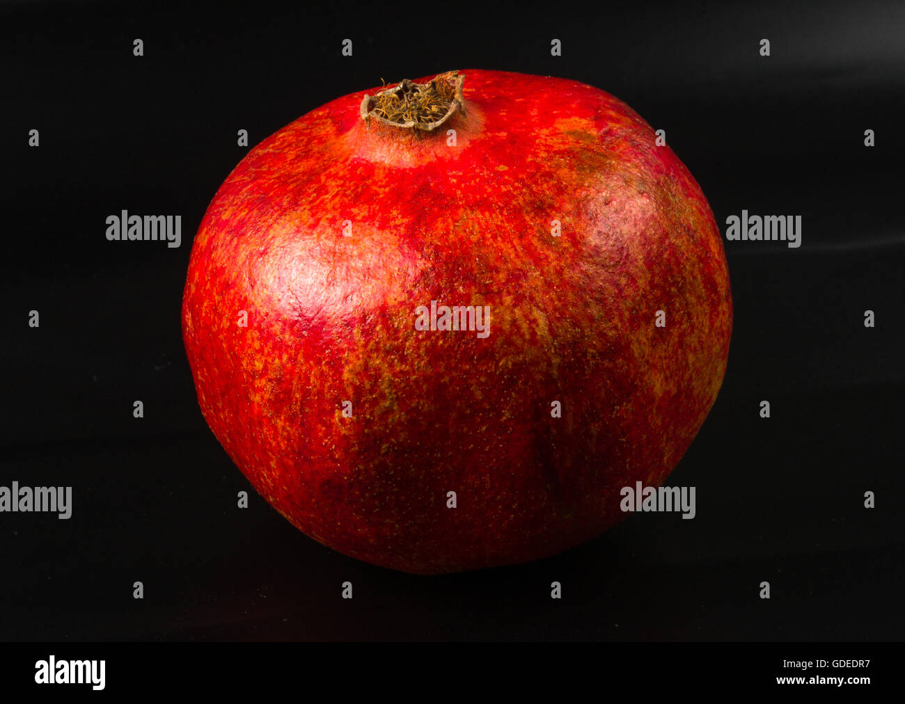 Big Pomegranate fruit on black background, closeup Stock Photo - Alamy