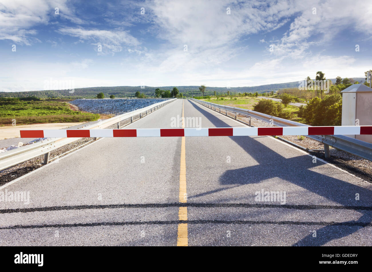 Red barricade at stop area ,barrier or blackade with long road o street ...